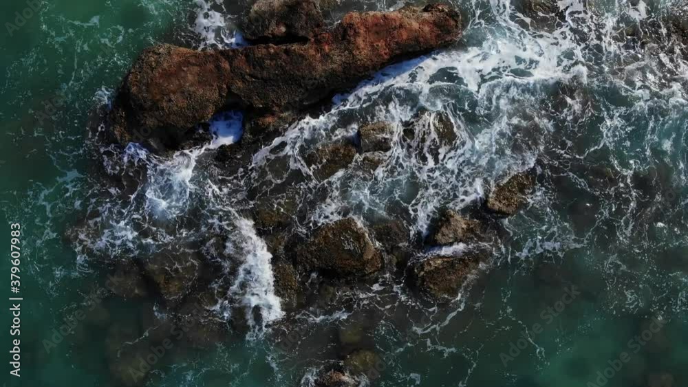 Small sea waves wash and splash at shallow place, rock sink in water ...