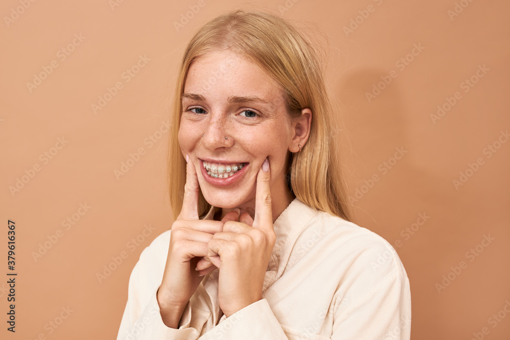 Portrait of charming teenage girl with freckles and facial piercing ...