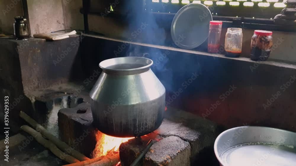 Traditional way of making food on open fire in old Indian kitchen in a ...