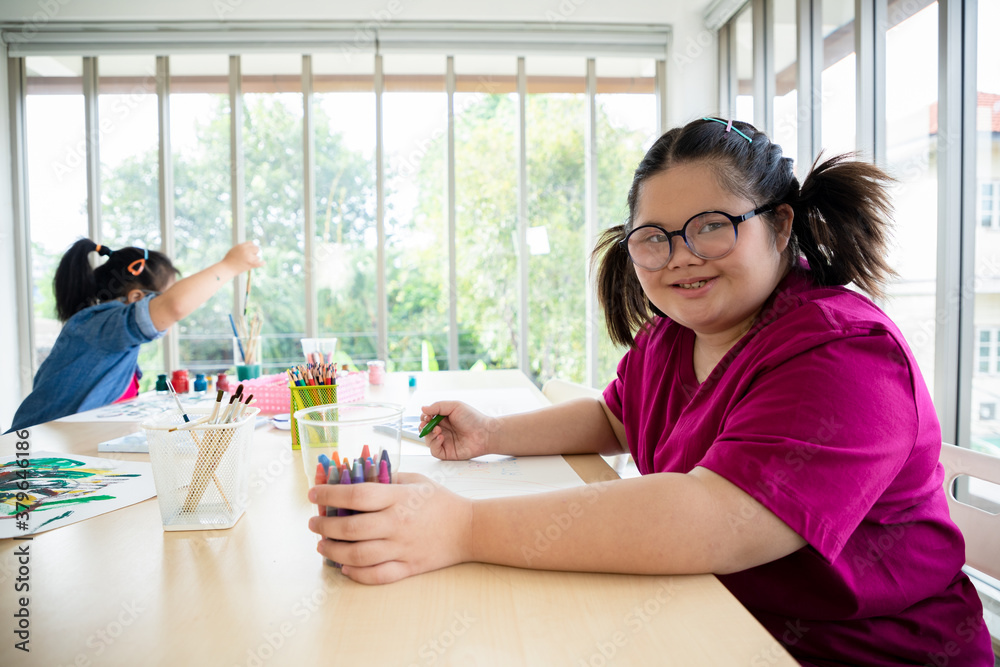 Young girls disabilities Or Down's syndrome learning about drawing ...