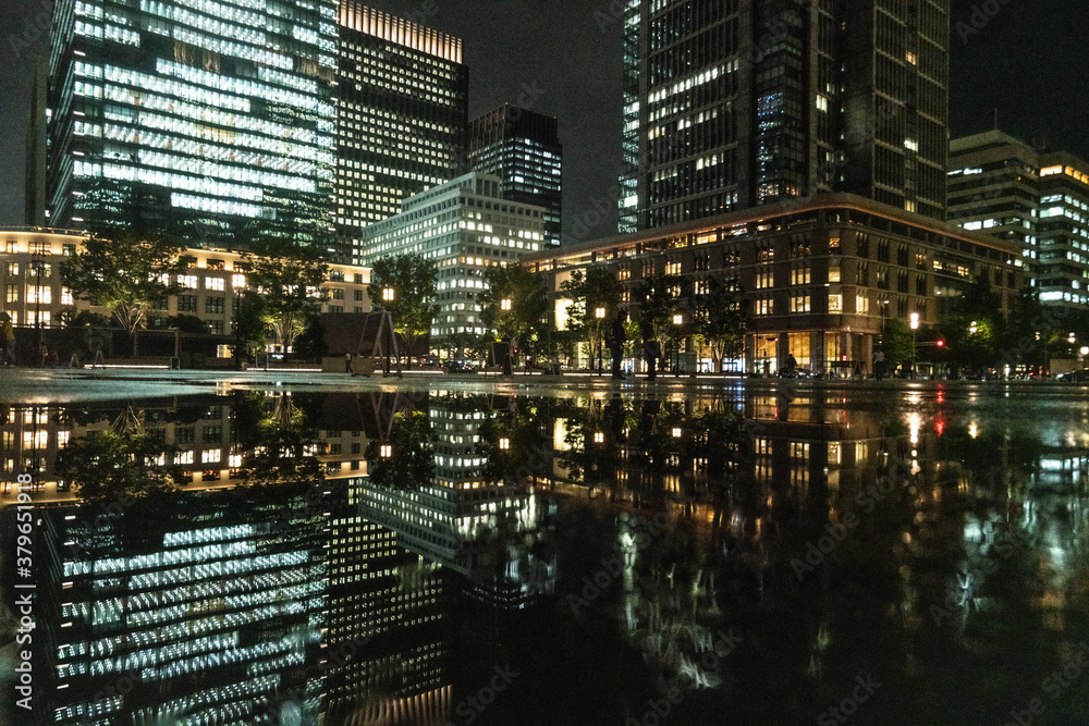 Tokyo Station Marunouchi after the rain with a beautiful mirror surface ...