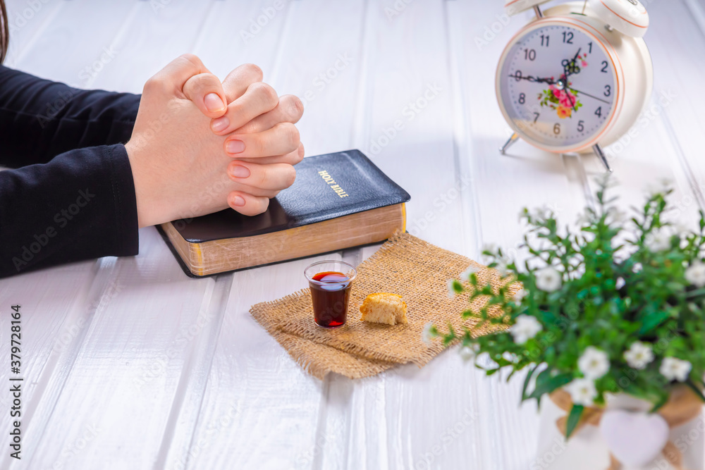 Young woman praying and Taking communion - the wine and the bread ...