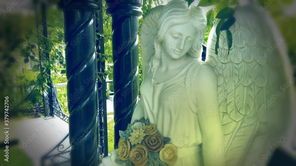 Figure of a praying angel. A very ancient stone statue. Death. Sad ...