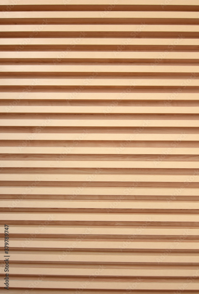 Light brown slats of wood. Lines of wooden slats form a striped texture ...