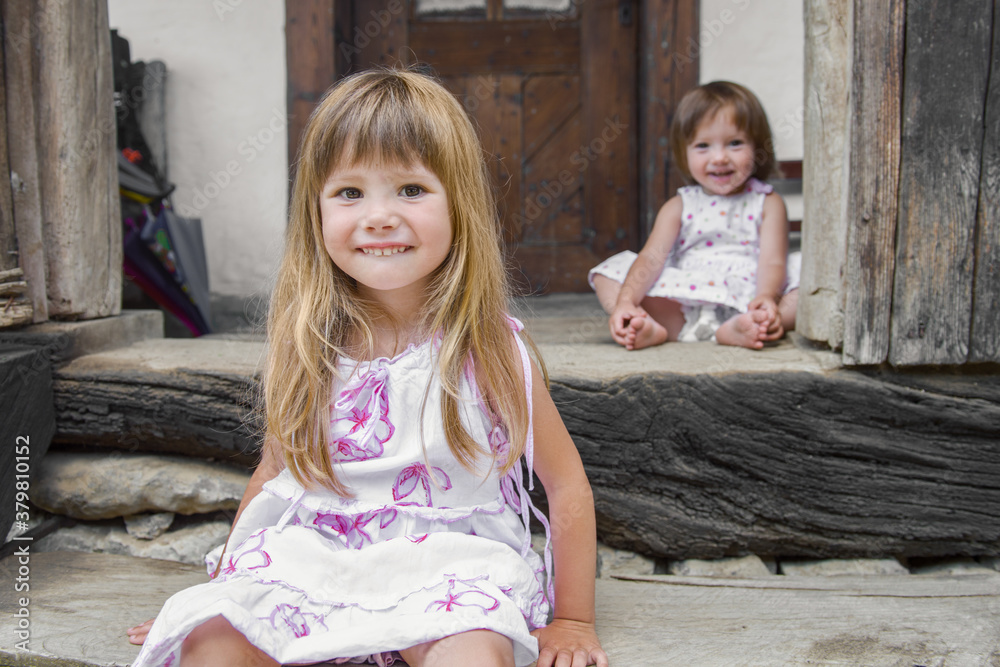 Toddler girl making a face in front of camera while little siste Stock ...