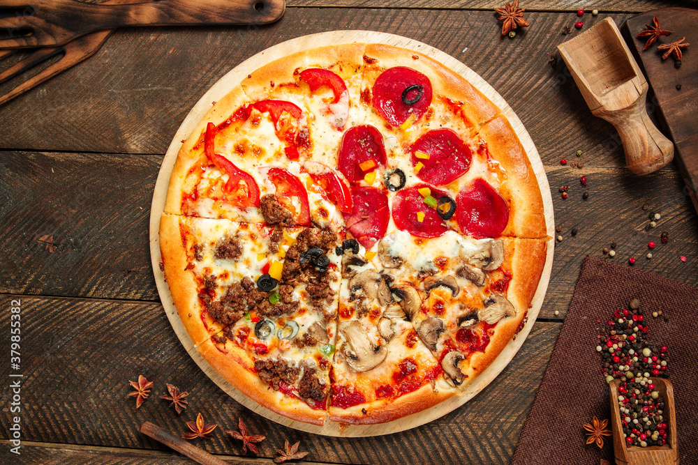Four seasons pizza with different toppings Stock-Foto | Adobe Stock