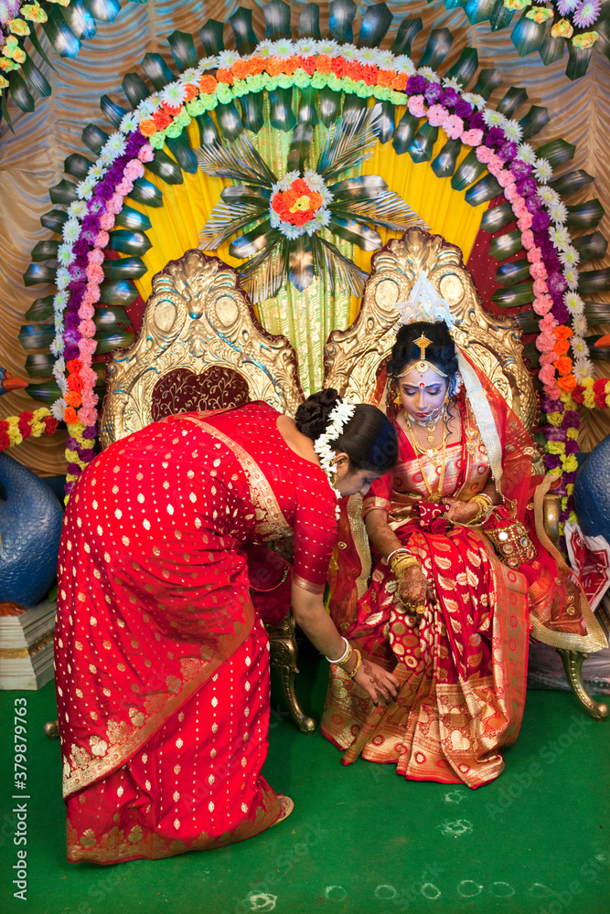 Indian woman adjusting saree to newly married bride Stock Photo | Adobe ...