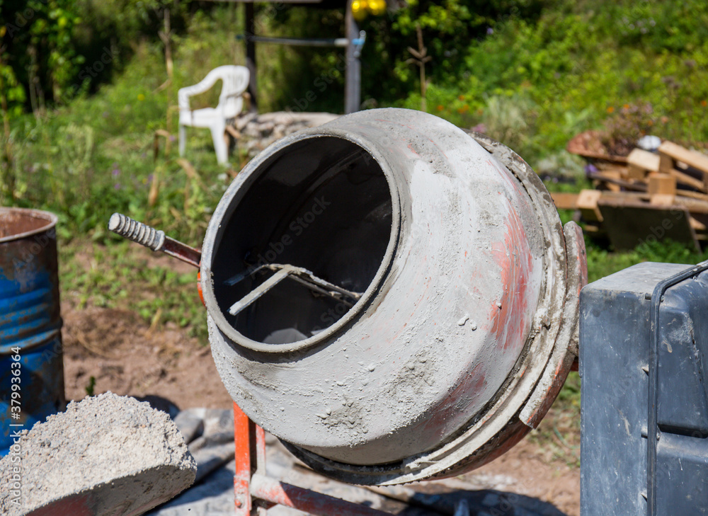 concrete mixer, construction work in progress. Mixer positioned and ...