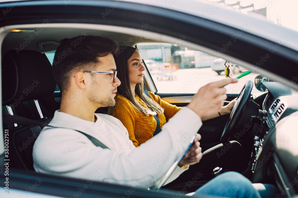 Driving school or test. Beautiful young pregnant woman learning how to ...