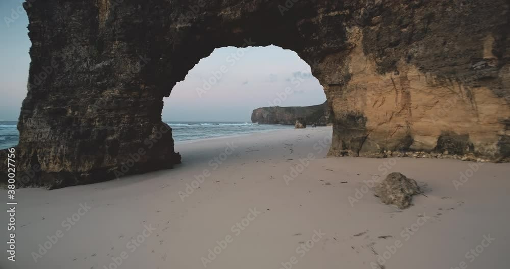 Giant hole of rock wall at sand beach, ocean bay in aerial view. Unique ...