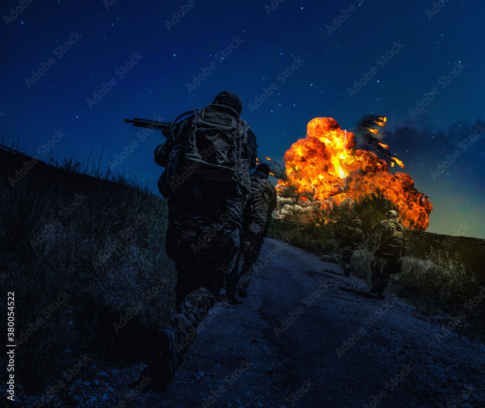 Army soldiers loaded with ammunition, running on battlefield at night ...