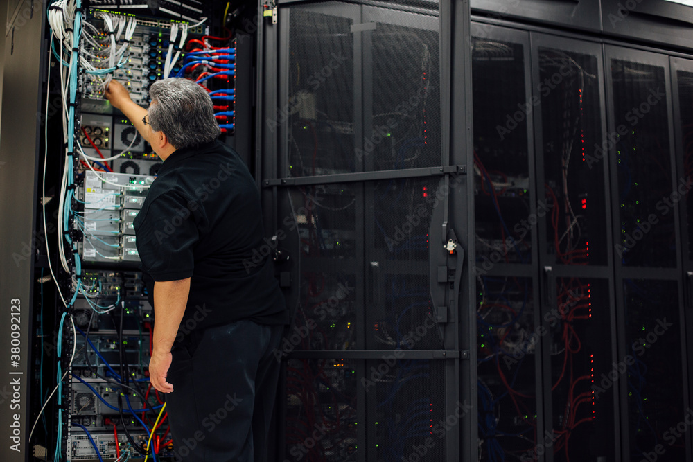 IT computer expert solving problems in server room Stock Photo | Adobe ...