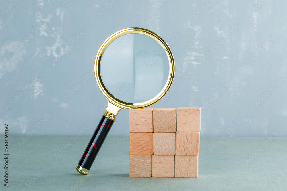 Conceptual of search with wooden blocks, magnifying glass on sage color ...