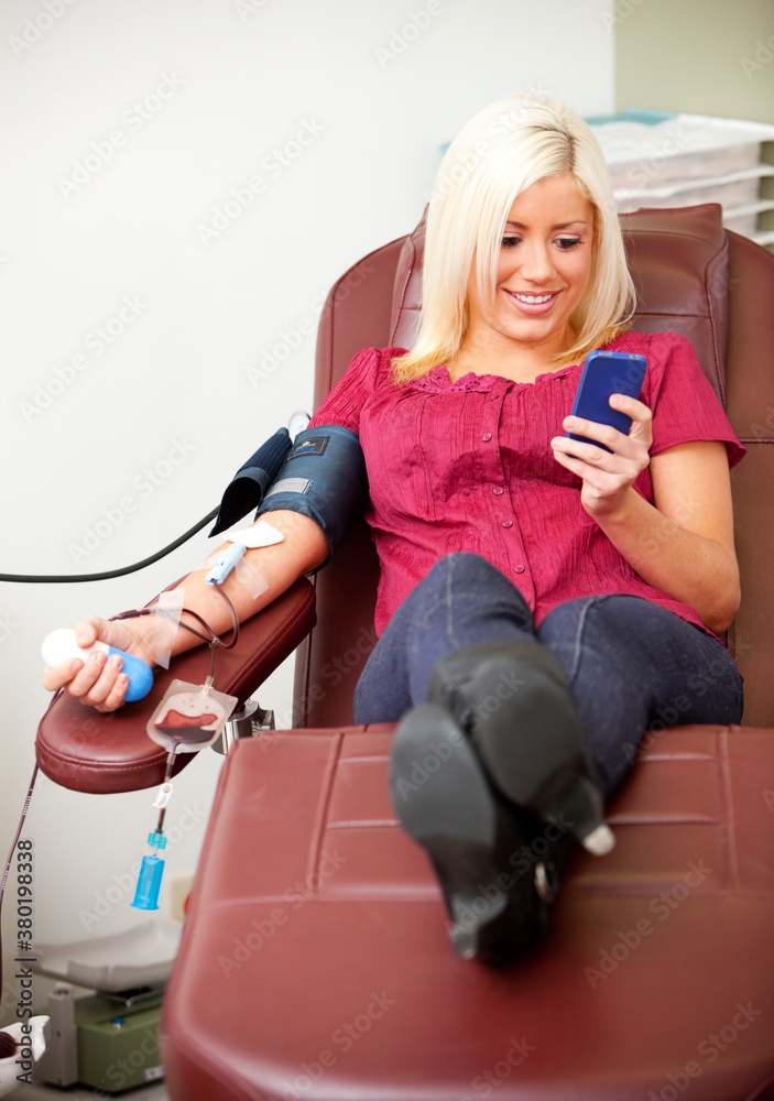 Blood Bank: Woman Uses Cell Phone While Donating Blood Stock Photo ...