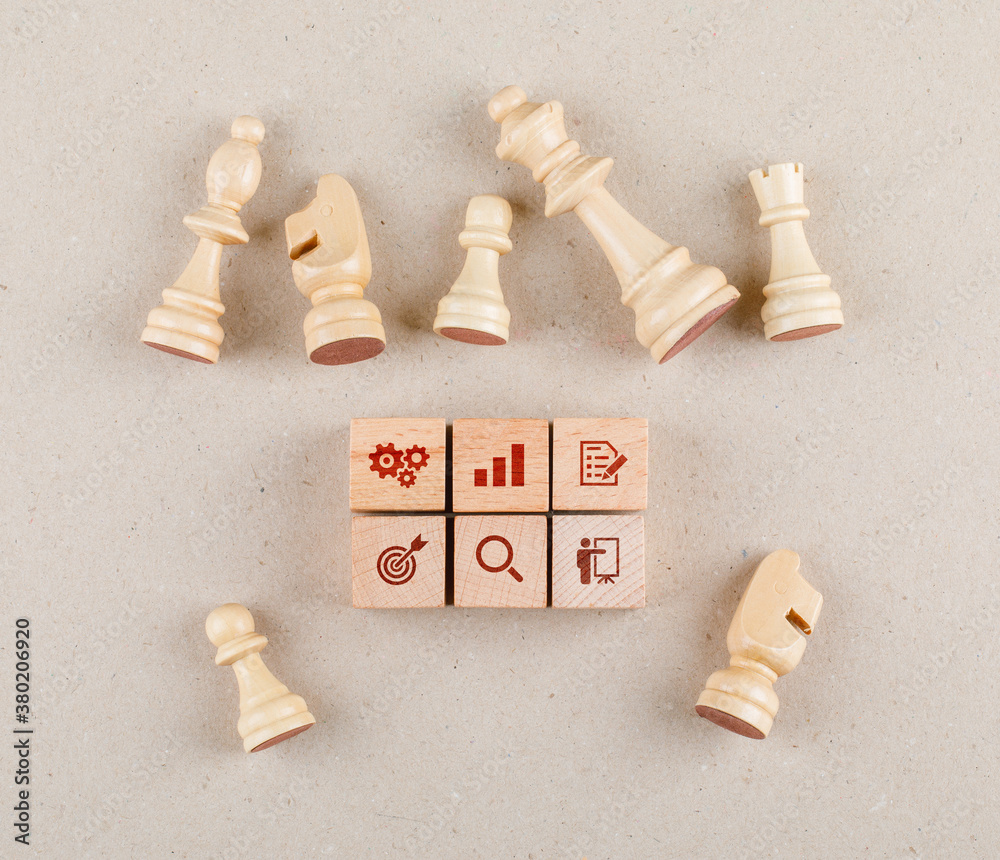 Conceptual of strategy with wooden blocks with icons, chess figures on ...
