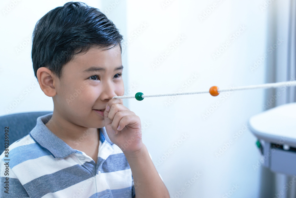 Asian boy using Brock string to exercise their eye muscles, Eye vision ...