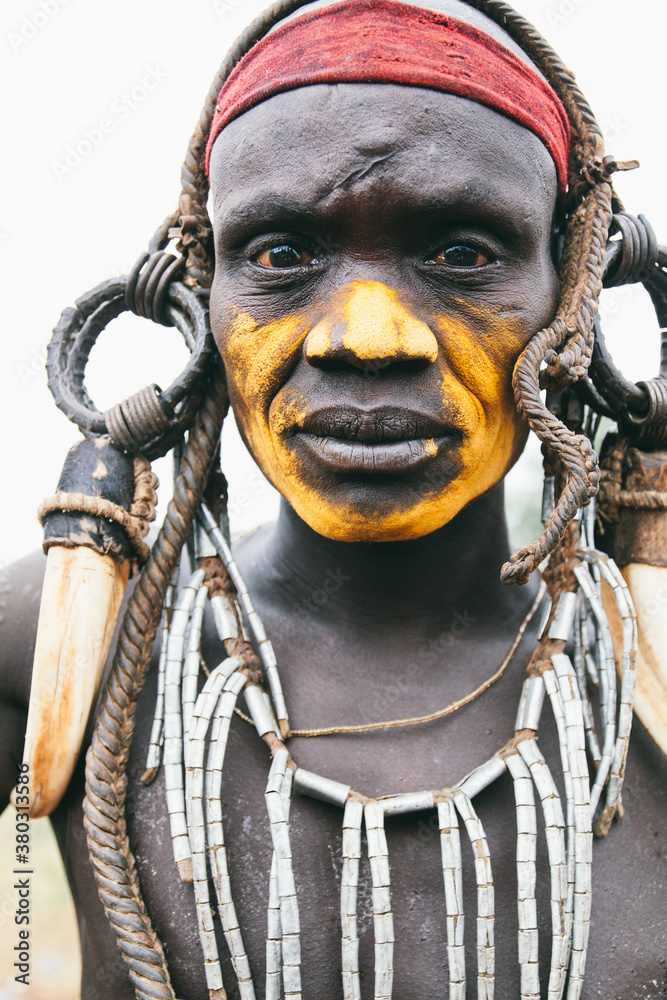 Mursi tribe man portrait with traditional clothes. Mago National park ...