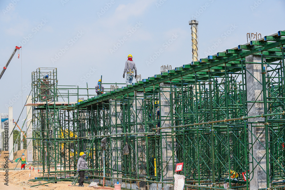 Construction workers are installation scaffolding for support structure ...