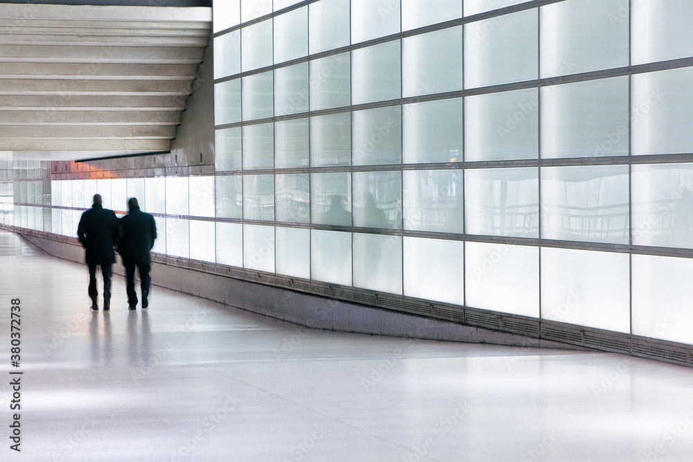 Europe, Germany, Berlin, glass walled passageway in modern building ...