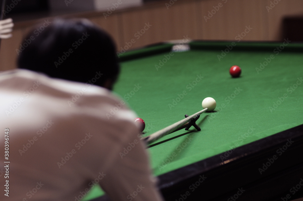 A man's hand playing snooker in a bar Snooker ball on the table ...