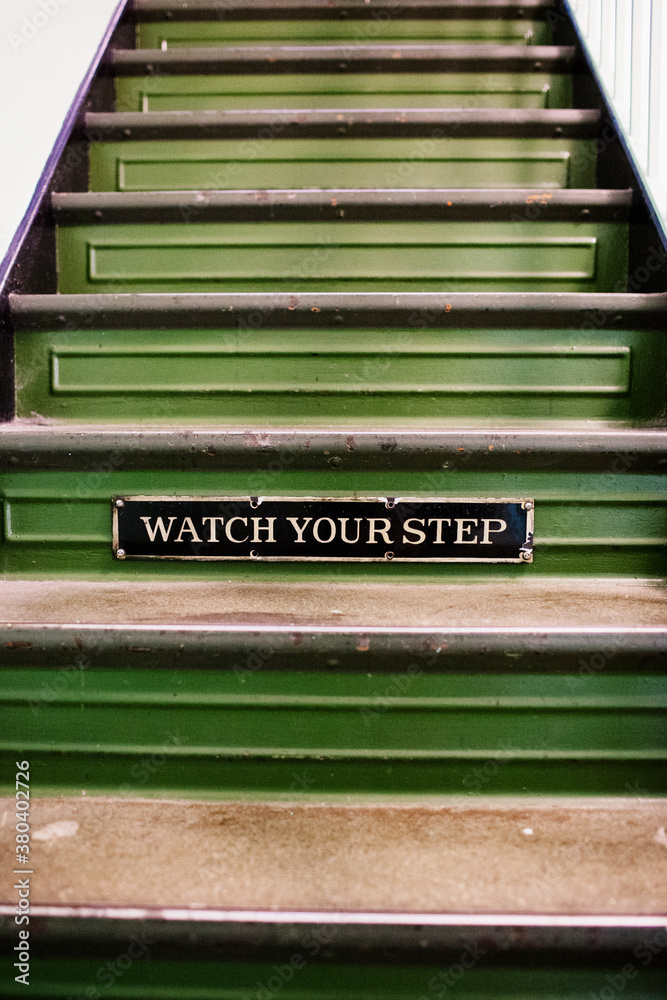 watch your step"" sign on a flight of stairs ภาพถ่ายสต็อก | Adobe Stock