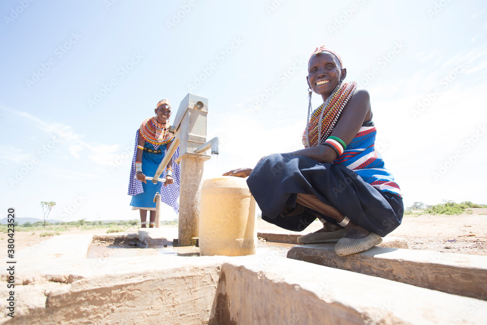 Samburu women collecting water from well in desert. Kenya. Stock Photo ...