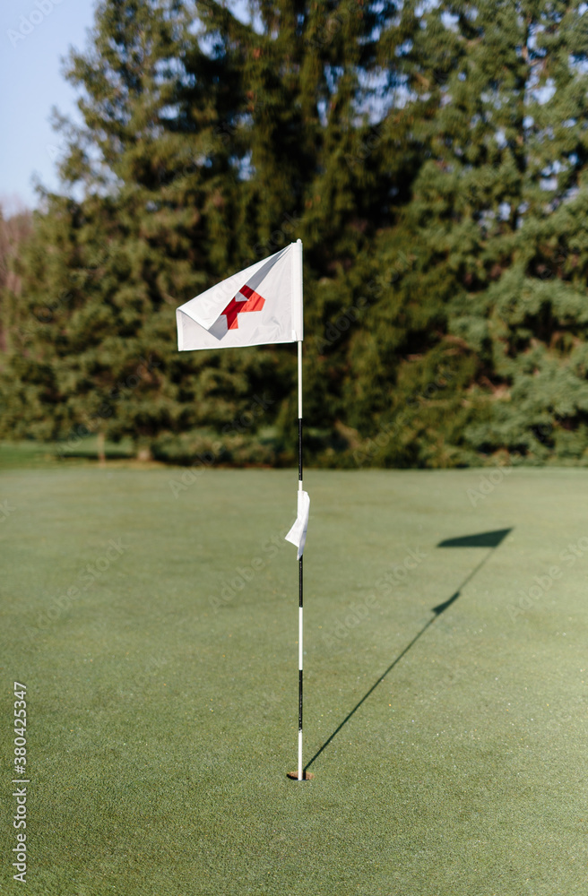 Putting green flag on golf course Stock Photo | Adobe Stock