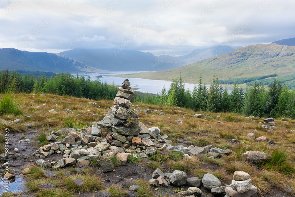 Rock stack in front of Loch Loyne in Scotland Stock Photo | Adobe Stock
