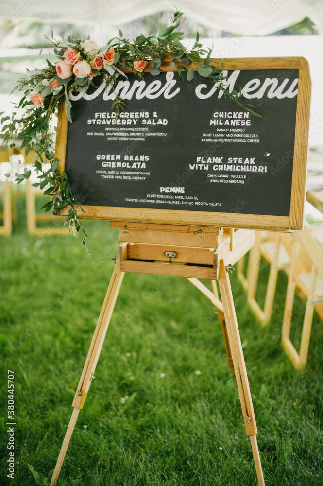 Handmade hand painted dinner menu on chalkboard sign with flower ...