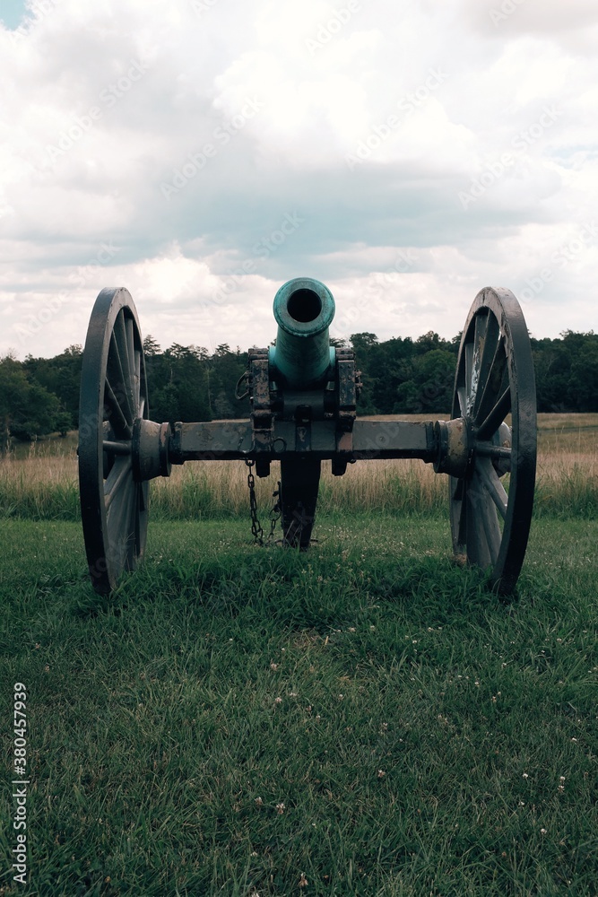 An old antique historic Civil War cannon in a field of green grass and ...