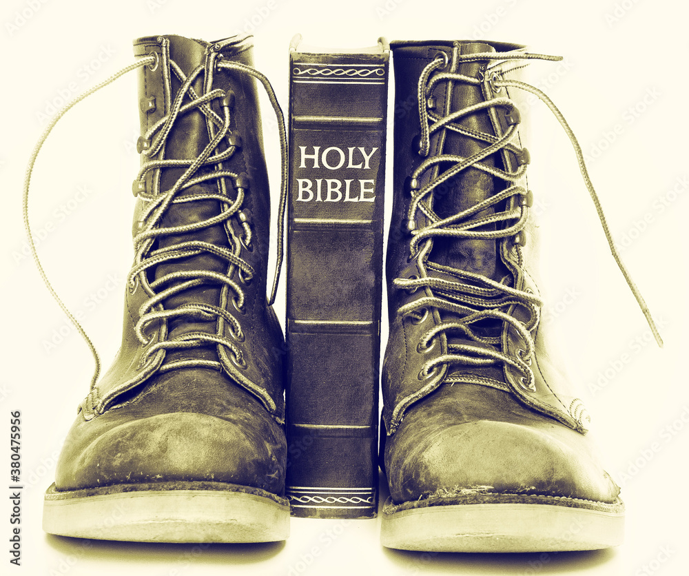 Bible and boots on gray background Stock Photo | Adobe Stock