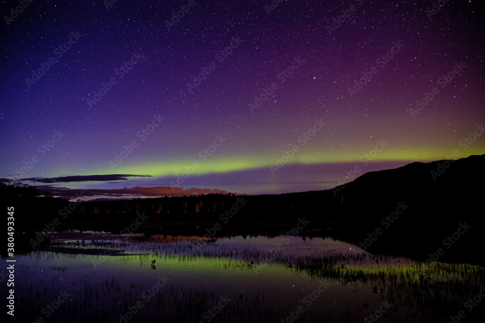 Northern lights, aurora borealis, over the lake in the Northern ...