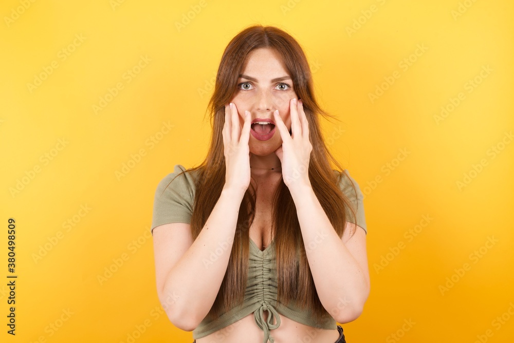 Stupefied young woman with long hair style, expresses excitement and ...
