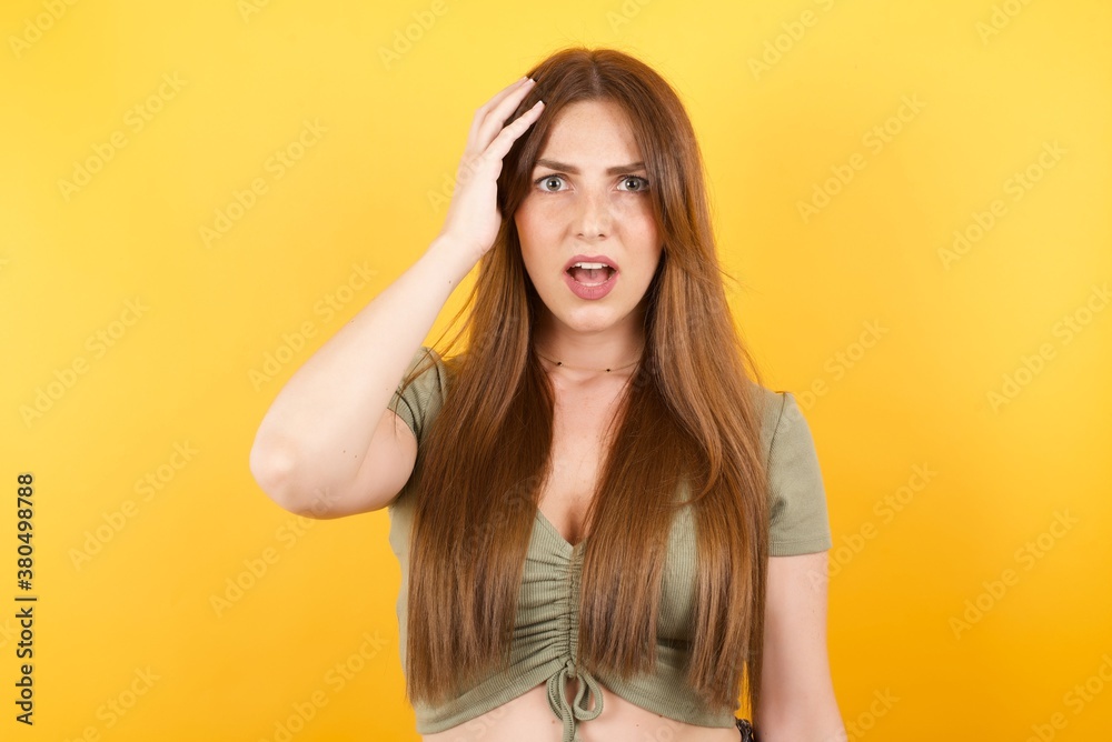 Embarrassed attractive caucasian female dressed in rd shirt, with ...