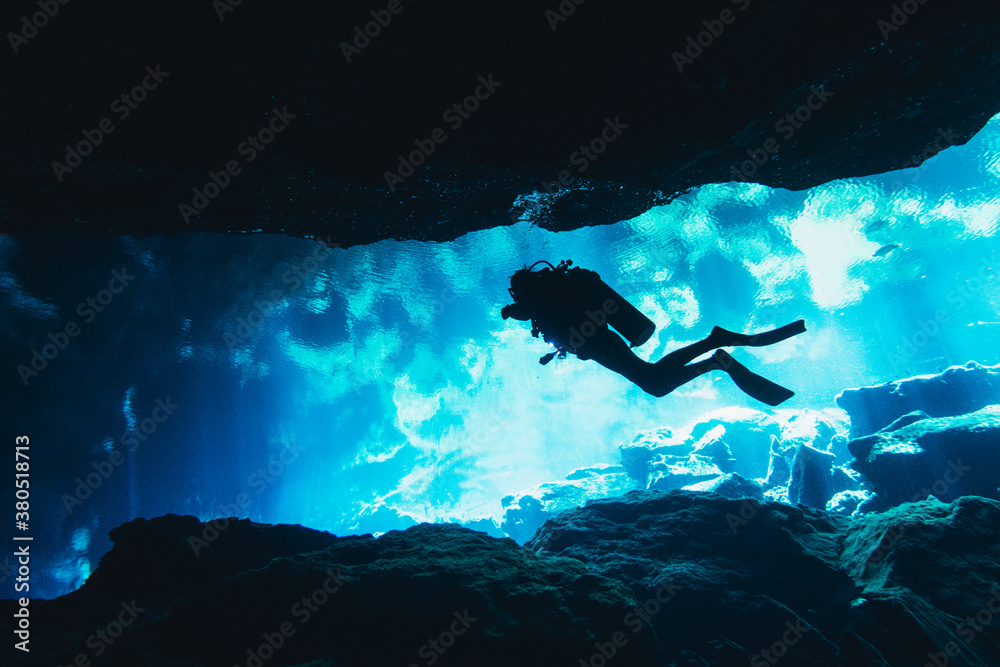 Silhouette of scuba diver doing cave diving in a cenote in YucatÔøΩÔøΩn ...
