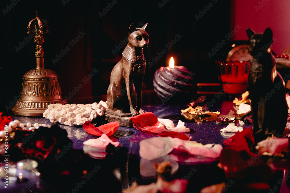 Mystical table with occult attributes. Stone rosaries, candles, antique ...