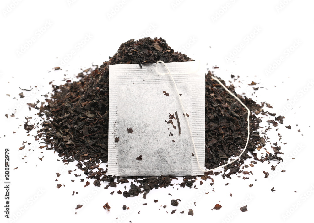 Dry black tea leaves pile with blank filter bag isolated on white ...