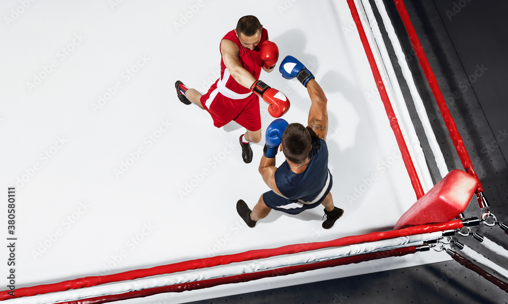 Fire. Two professional boxers boxing on white background on the ring ...