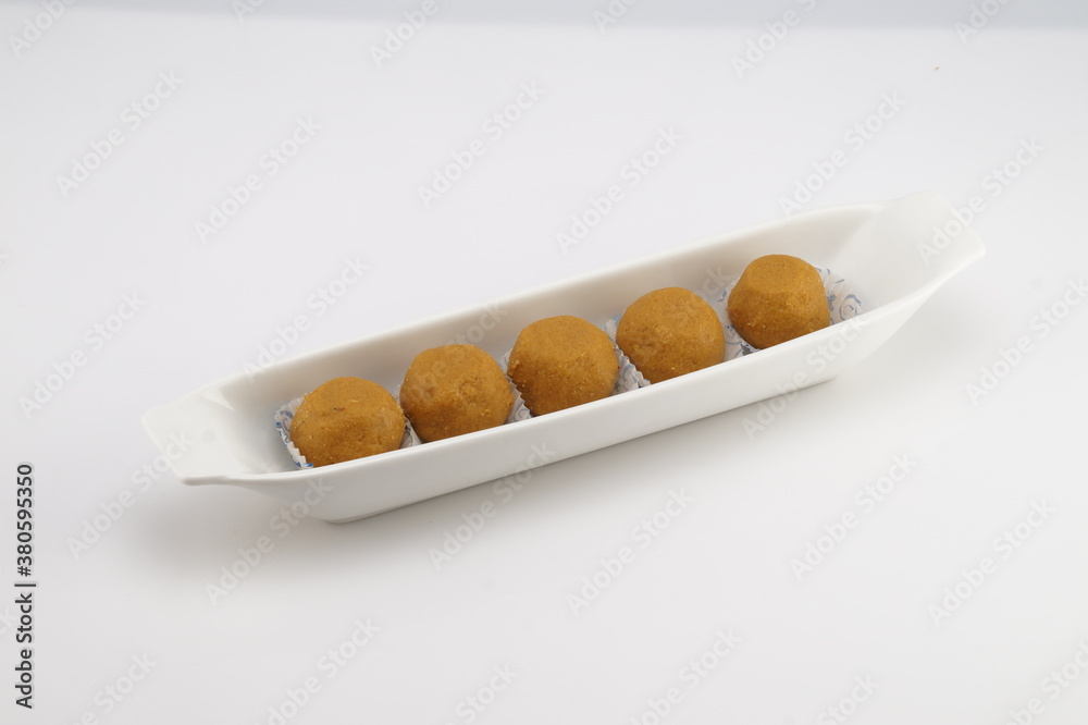 Besan laddu is a popular Indian sweet dish made of besan (chickpea ...
