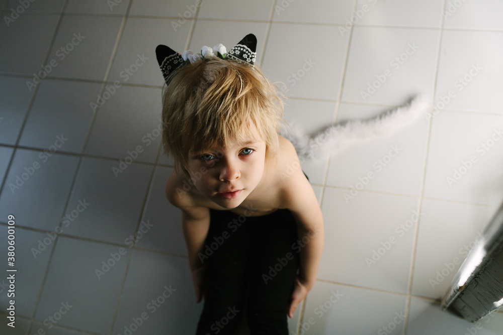 Little blonde girl with cat ears and tail. Stock Photo | Adobe Stock