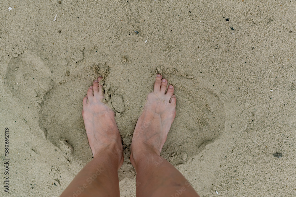 Foto de Feet naked barefoot without shoes burrow in the sand on a sandy ...