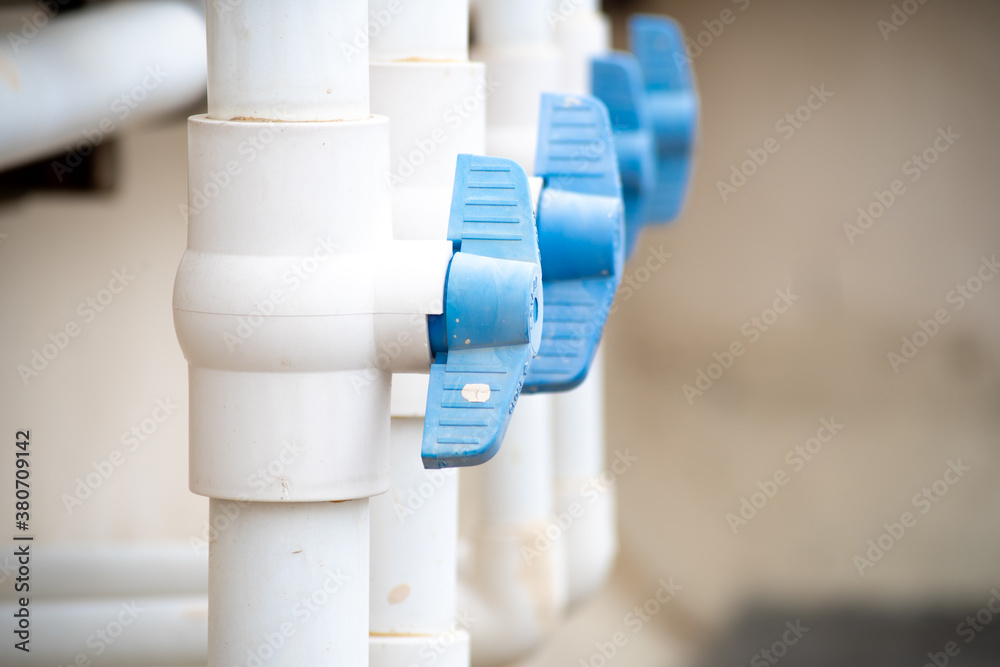 White PVC pipes with cool blue taps, valves and cocks that stand out ...