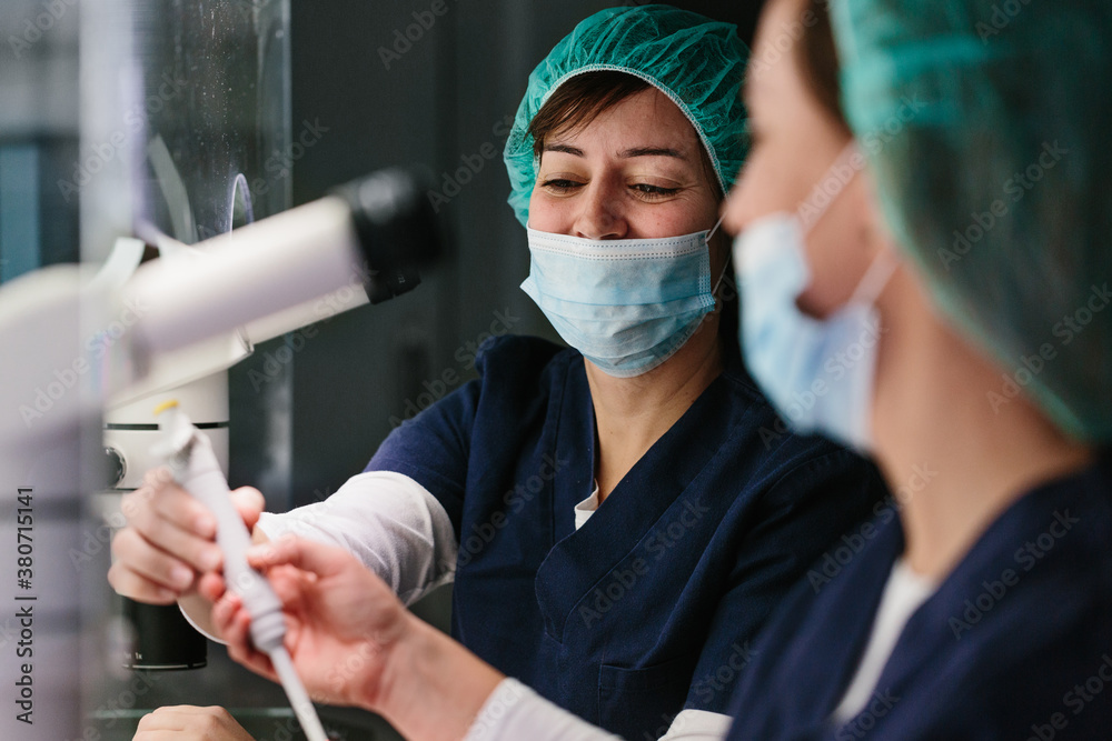 Biologists working on microscope in IVF laboratory Stock Photo | Adobe ...