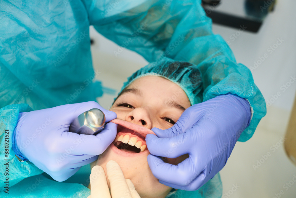 Boy getting operated in dental clinic Stock Photo | Adobe Stock