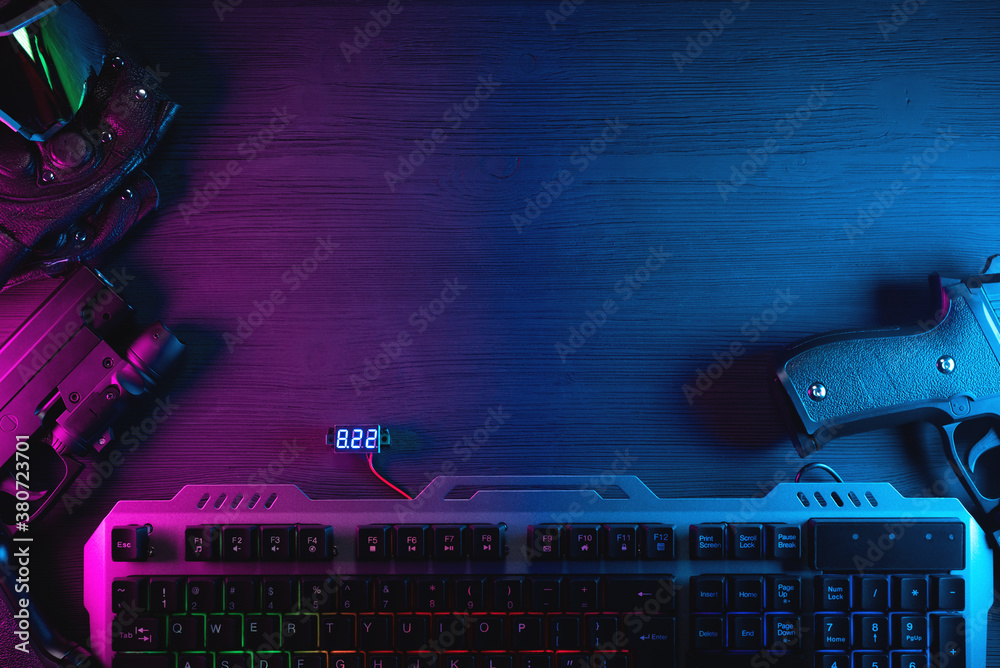 Toy guns, glasses and computer keyboard on the flat lay table ...