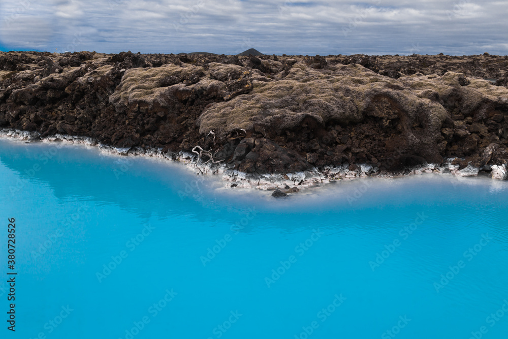 Turquoise water of the blue lagoon under a dramatic sky in iceland ...