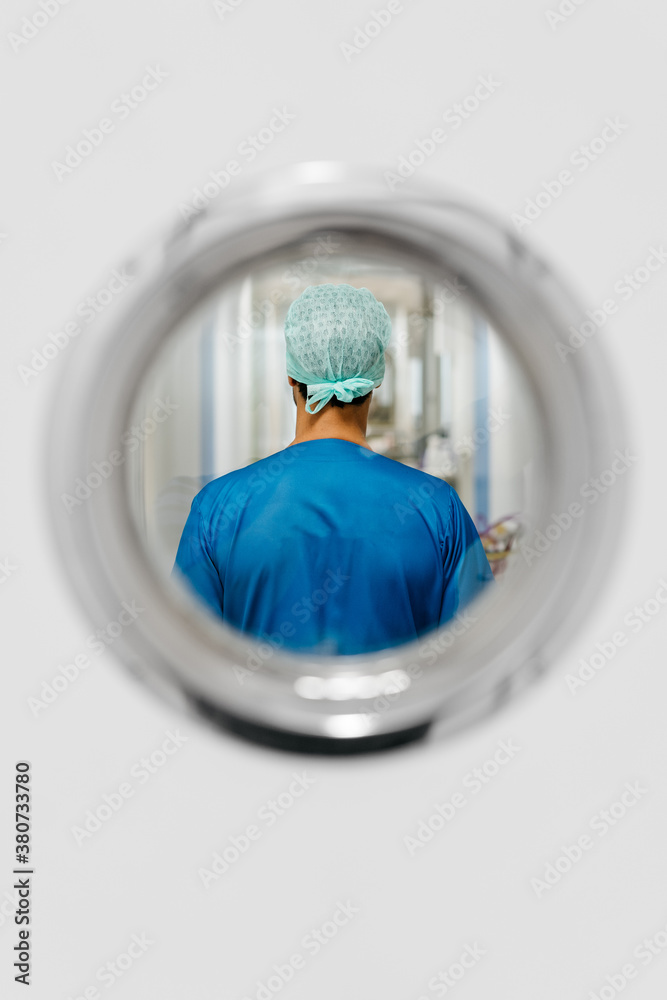 Back view of anonymous nurse through hospital door's window Stock Photo ...