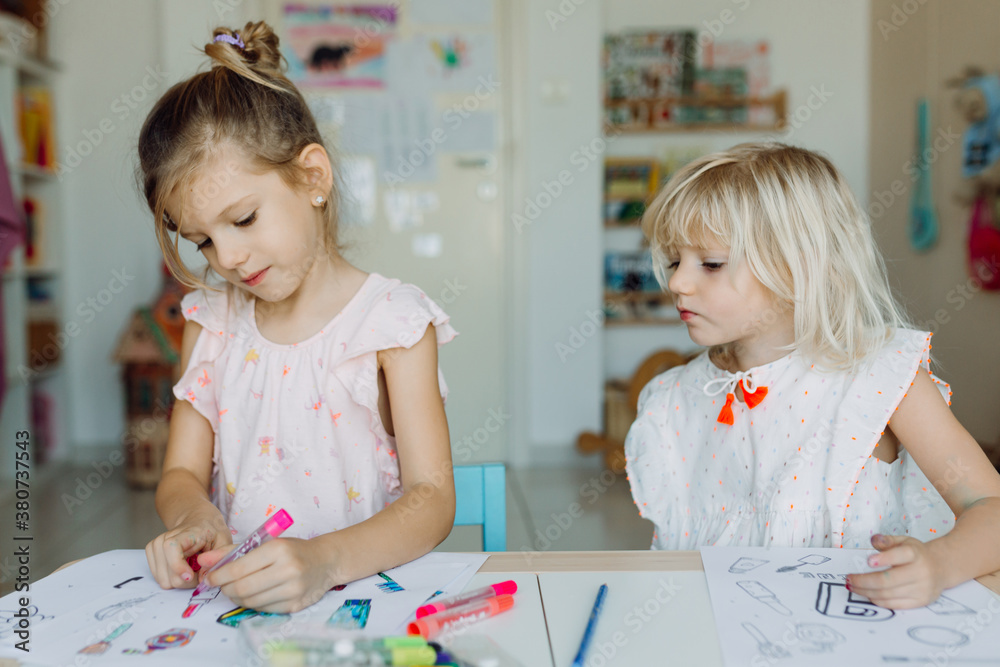 Two little girls coloring at home Stock Photo | Adobe Stock