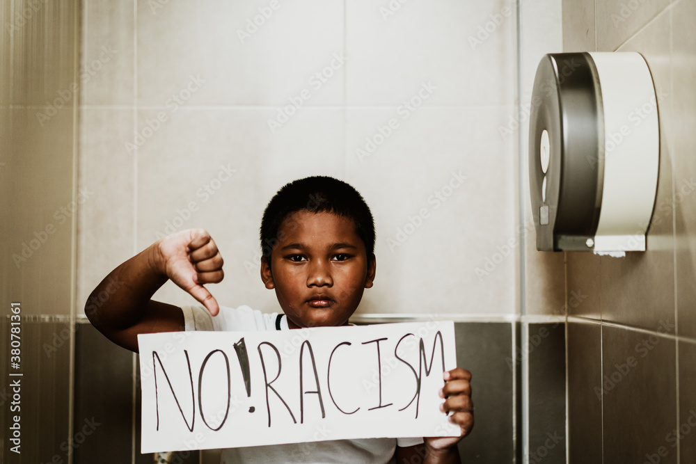 Foto de African american boy holding board No racism in toilet.No bully ...