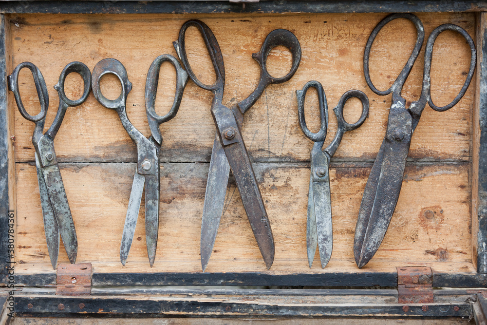 Old assorted scissors in a row on textured wood background Stock Photo ...